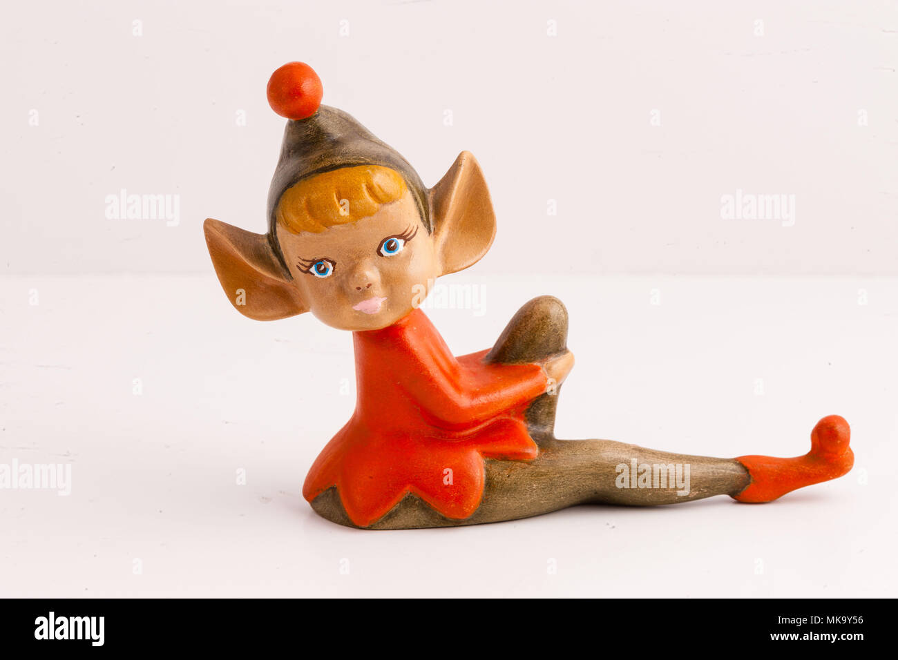 an handmade sitting elf figurine in red and brown Stock Photo - Alamy