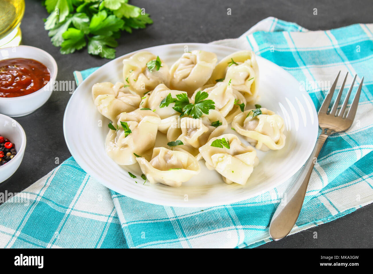 Homemade ready dumplings on a gray concrete table Stock Photo - Alamy