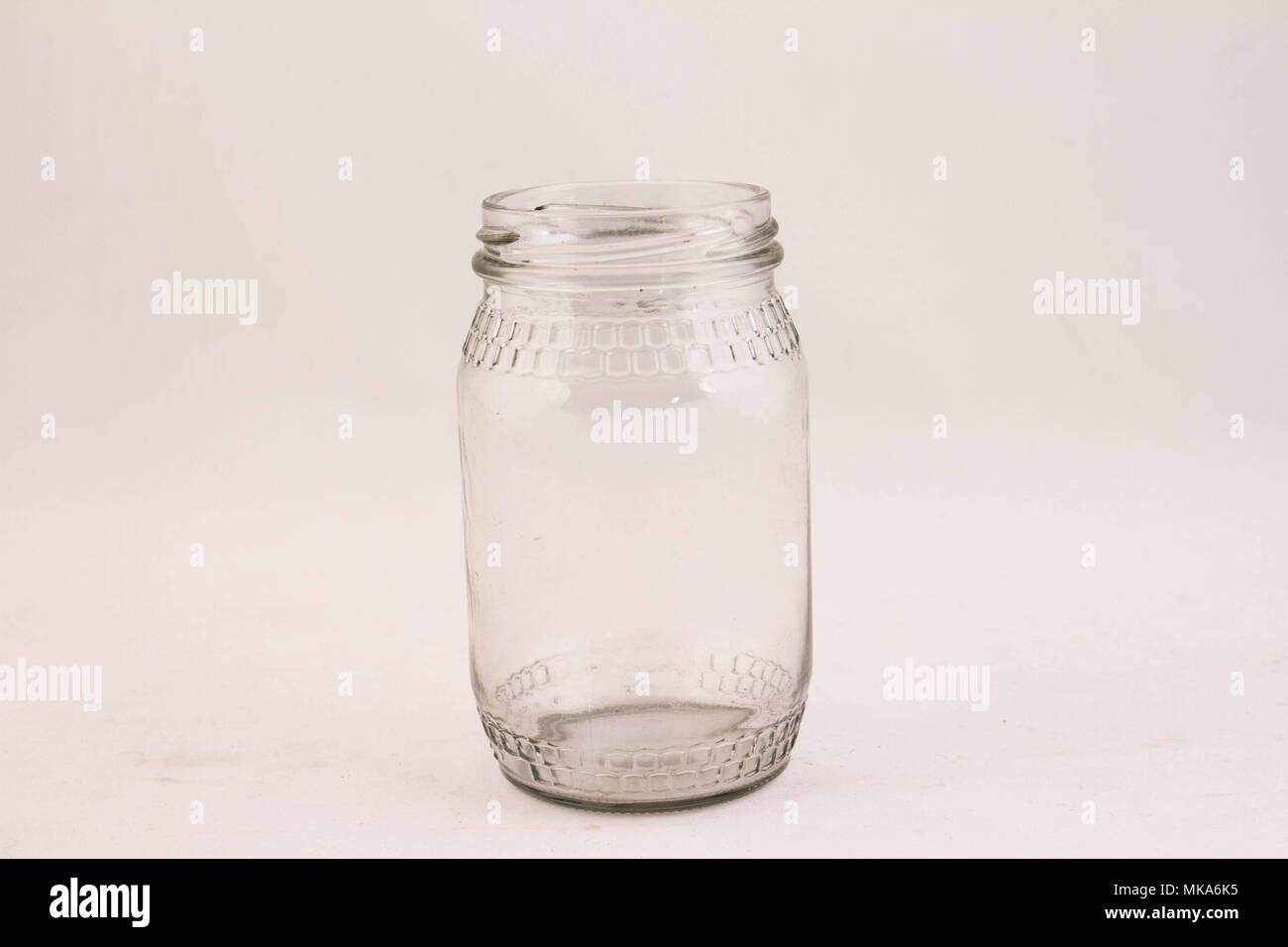 Empty clear glass jar isolated against a white background image with ...