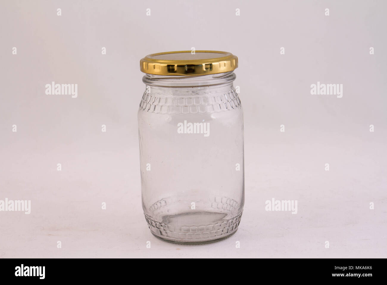 Empty clear glass jar isolated against a white background image with ...