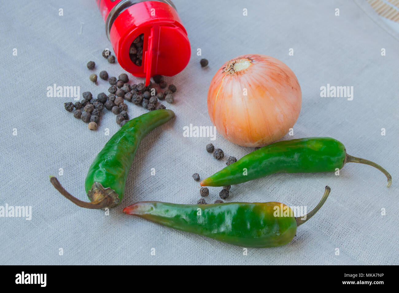 Spices. Burning peppers with onion on a linen kitchen cloth Stock Photo ...