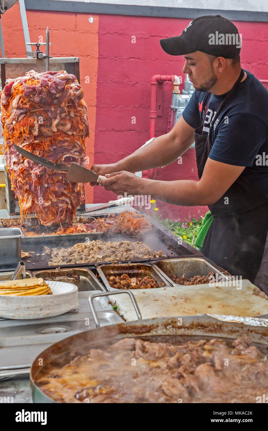 Detroit, Michigan USA - 6 May 2018 - A worker cooks meat during Detroit ...