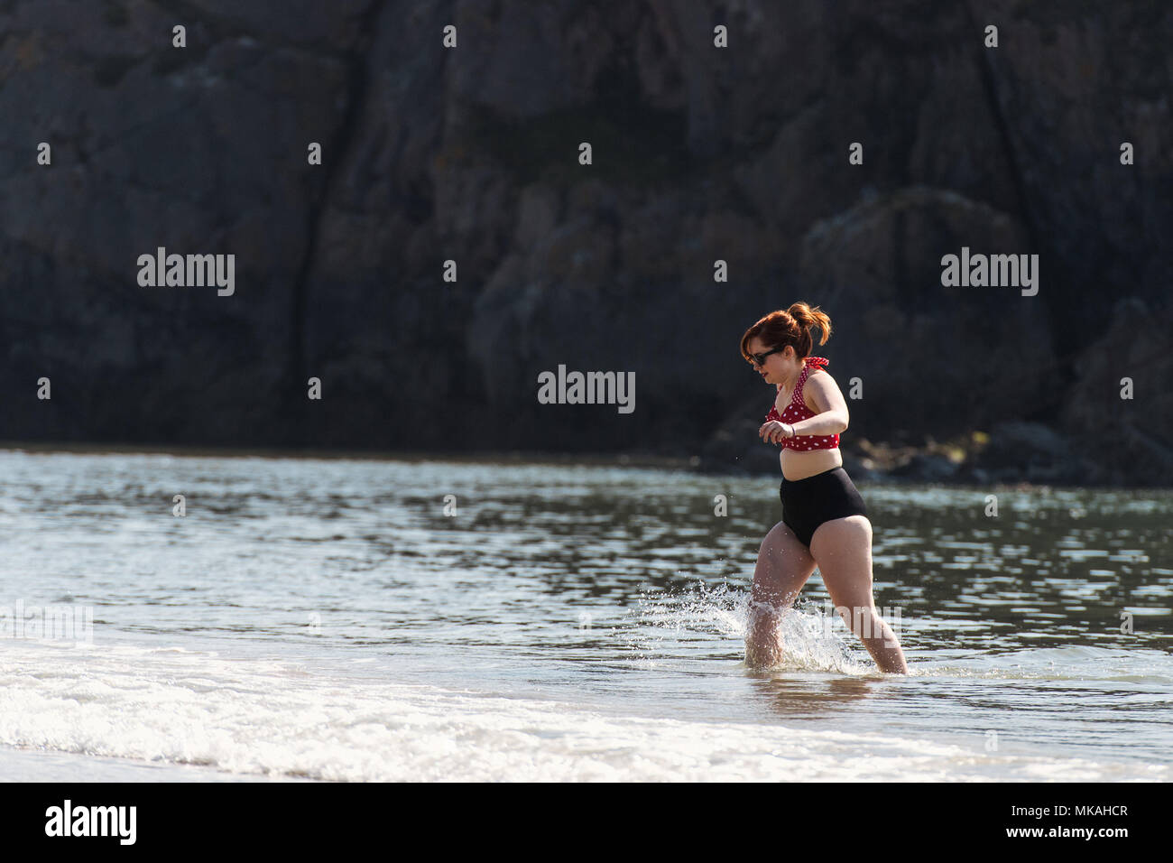Tenby, Wales. 7th May 2018. UK Weather: A woman takes a dip in the sea ...