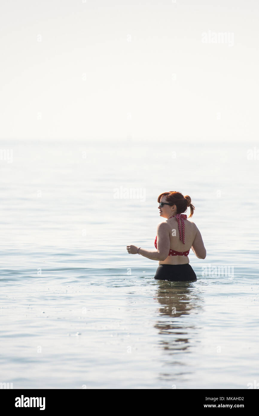 Tenby, Wales. 7th May 2018. UK Weather: A woman takes a dip in the sea ...