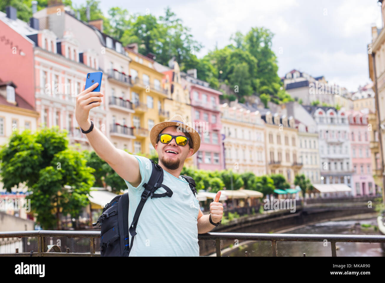 Handsome man taking selfie with mobile smart phone camera in european ...
