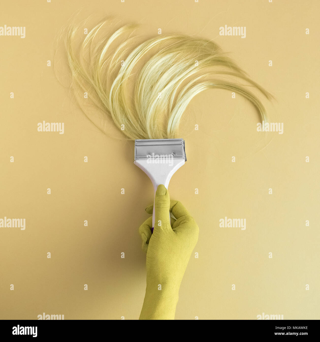 Hand holding paintbrush with long hair minimal abstract yellow creative ...