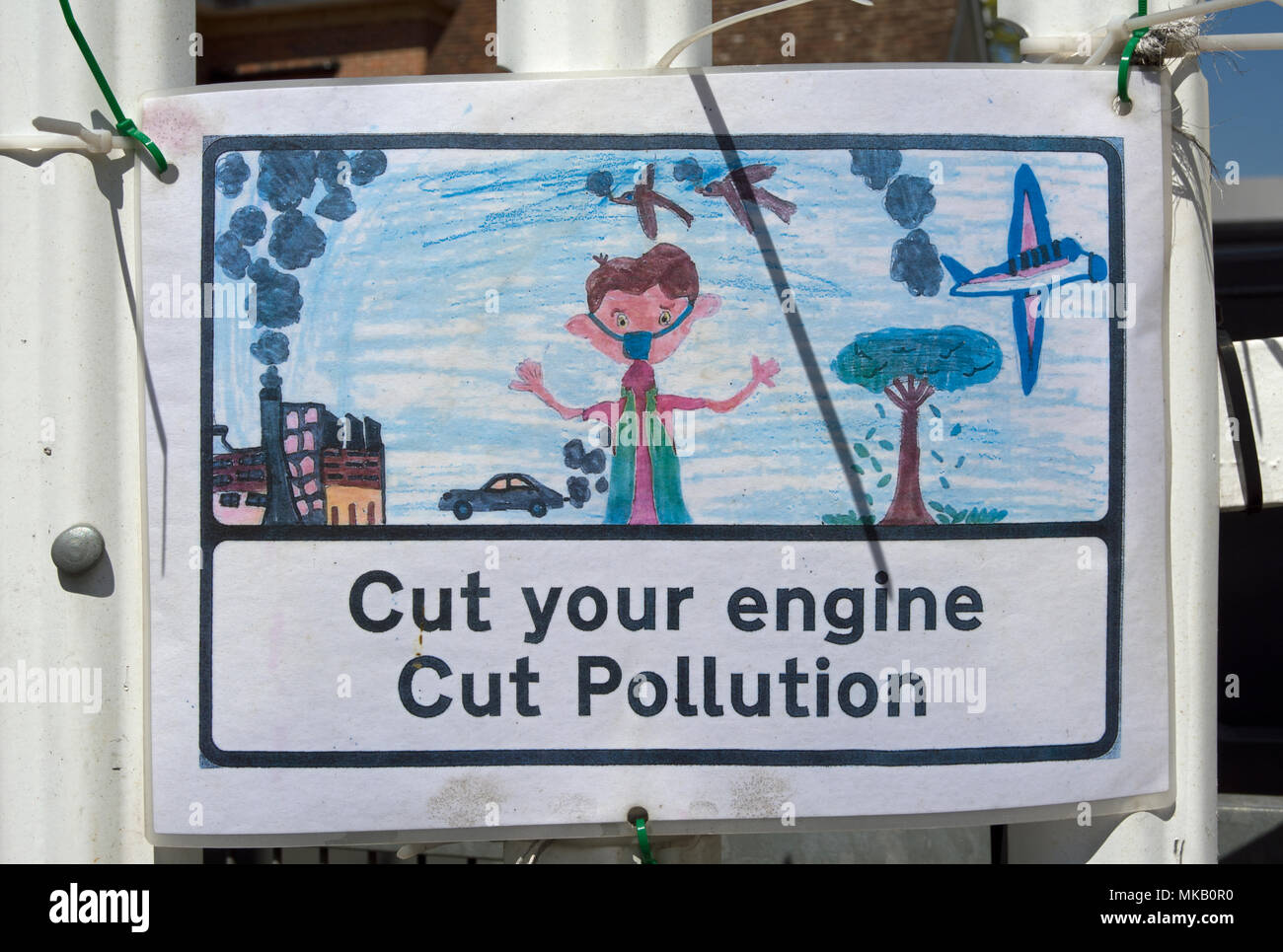 cut your engine cut pollution sign with child's drawing at a railway ...