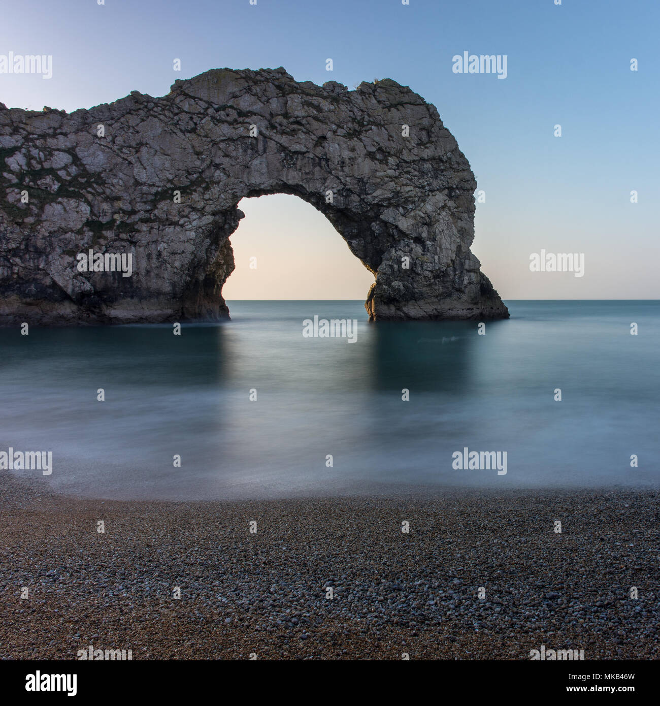 Early morning light shines through the natural limestone arch at Durdle ...