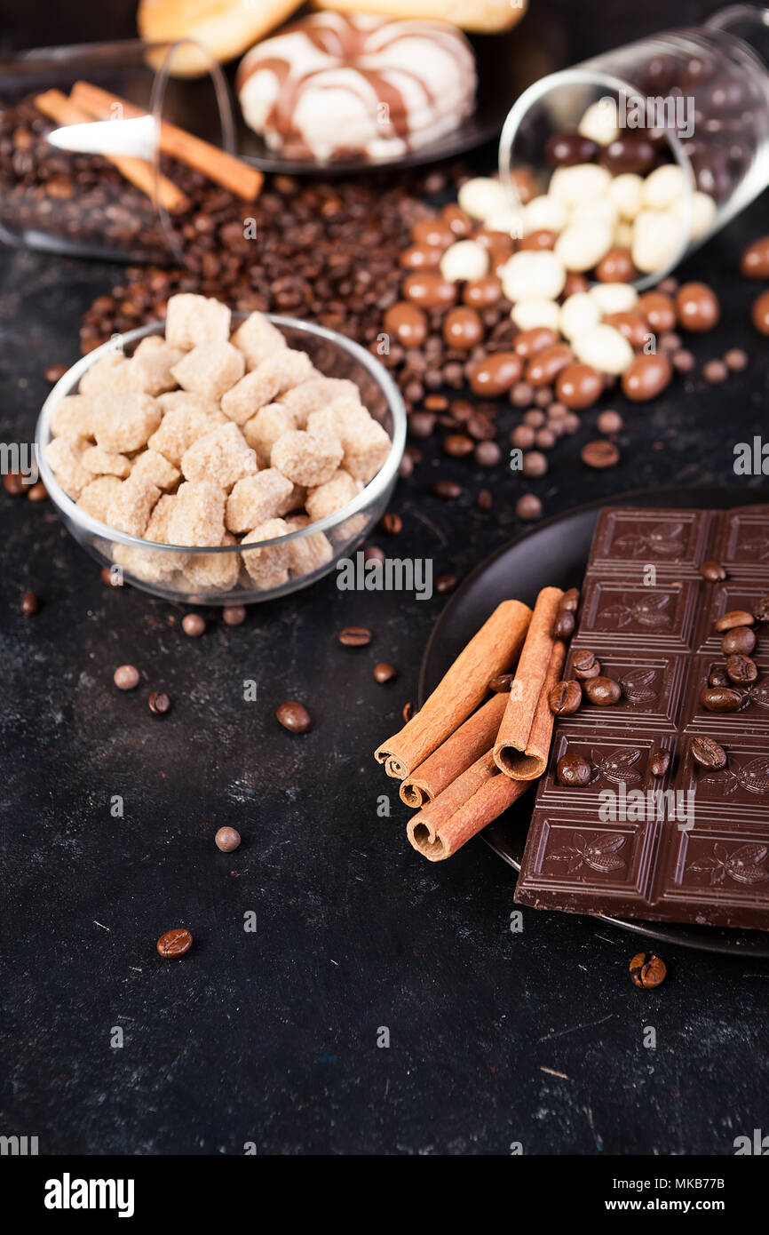 Chocolate tablets next to cinnamon rolls and other sweets and candies ...