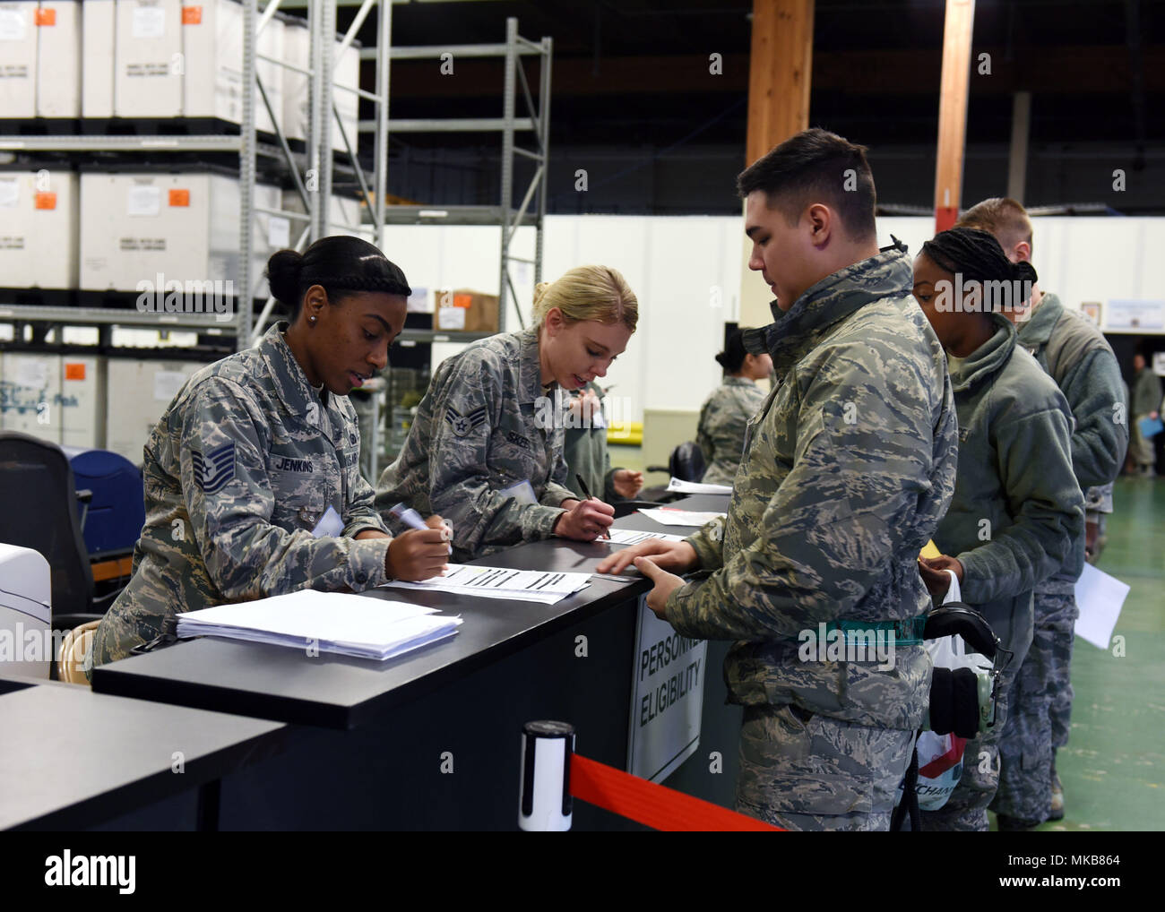 Members of the 627th Force Support Squadron process Airmen through a ...