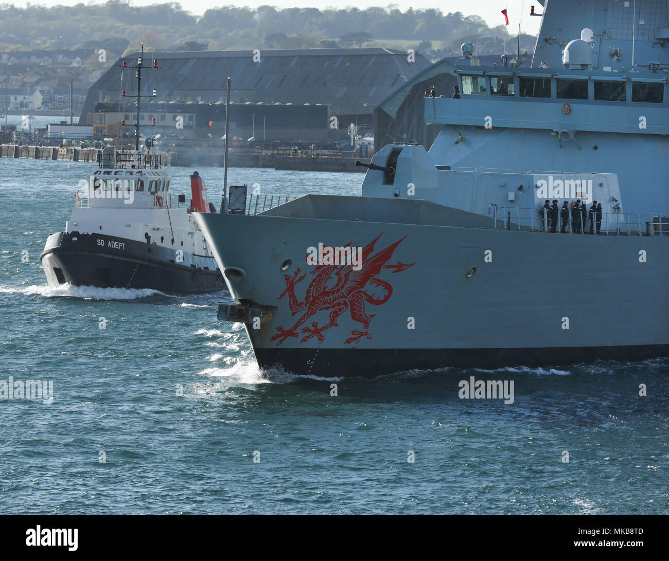 The Type 45 destroyer HMS Dragon leaving Plymouth accompanied by the ...
