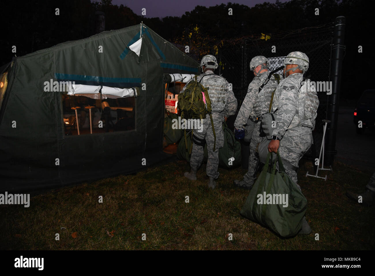 Members of the 66th Security Forces Squadron enter a tent at Camp ...