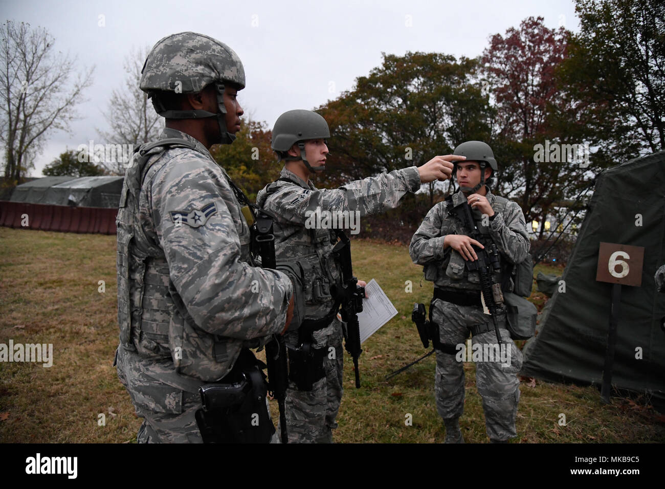 Airman 1st Class Michael Ionin, center, directs Airman 1st Class Joshua ...