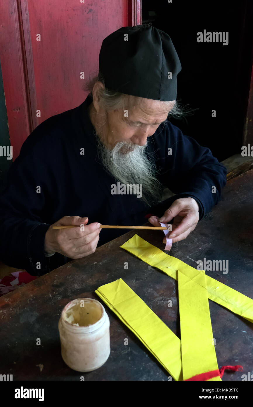 Monk working in temple near Water Curtain Cave or Shuilian Dong. Luomen ...