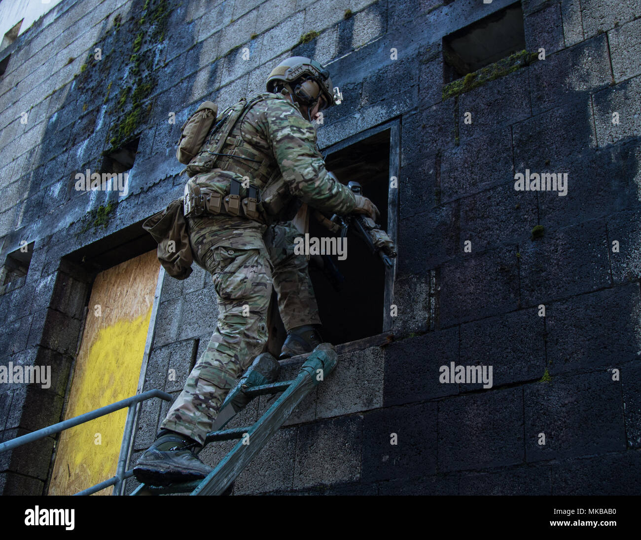 A U.S. Special Forces Soldier conducts building entry using ladders on ...