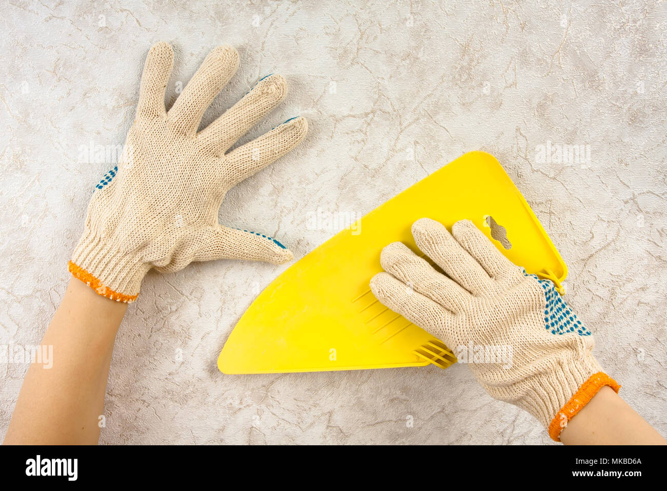 hands with spatula smoothing wallpaper on the wall Stock Photo - Alamy