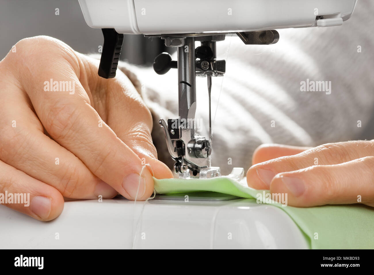 hands of seamstress working on the sewing machine Stock Photo - Alamy