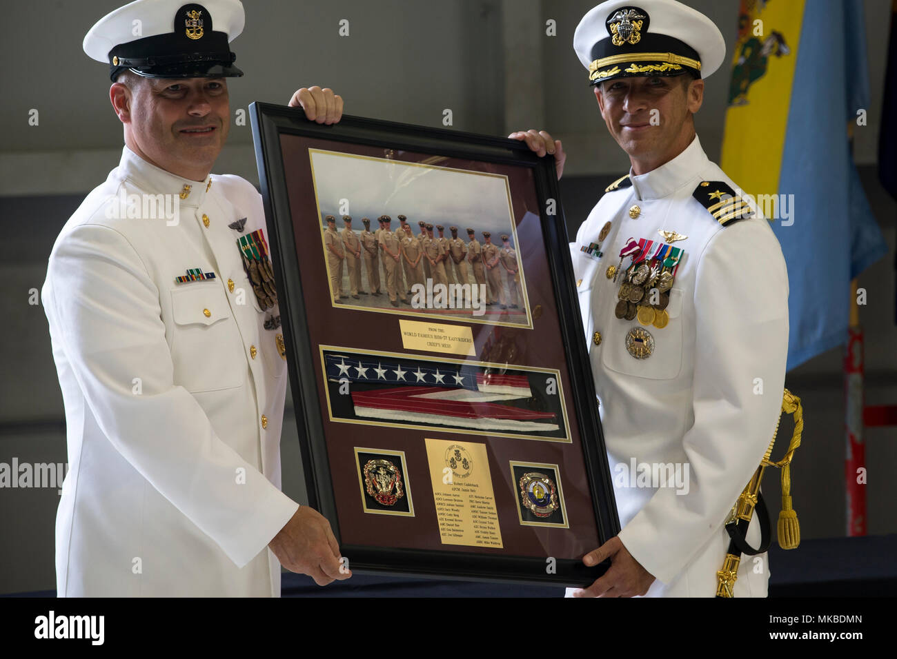U.S. Navy Cmdr. Teague Suarez, right, off-going commanding officer ...