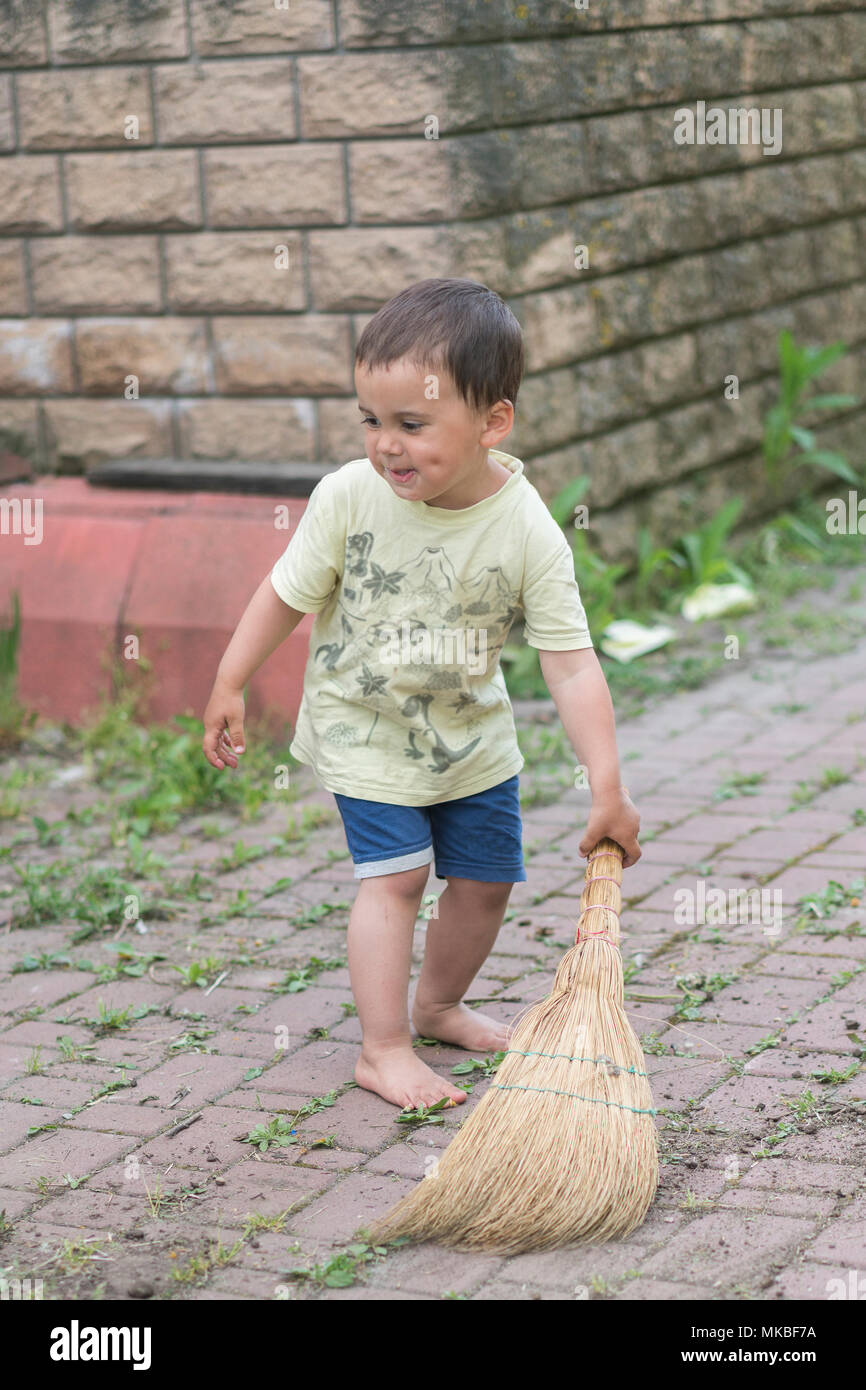 baby boy sweeping the yard. little boy my mother's helper, sweeping ...