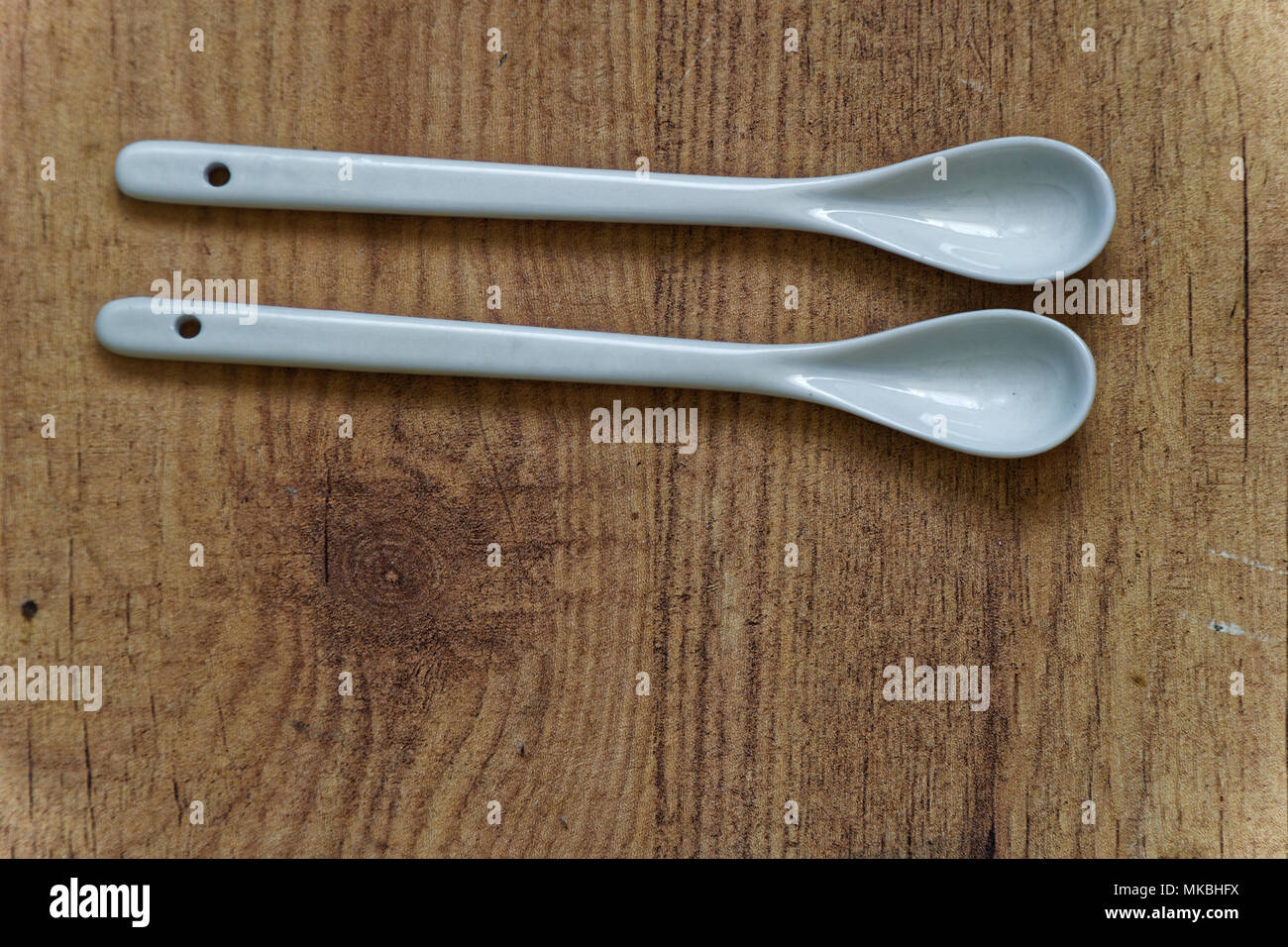 White ceramic spoon on wooden table, top view, kitchen background Stock ...