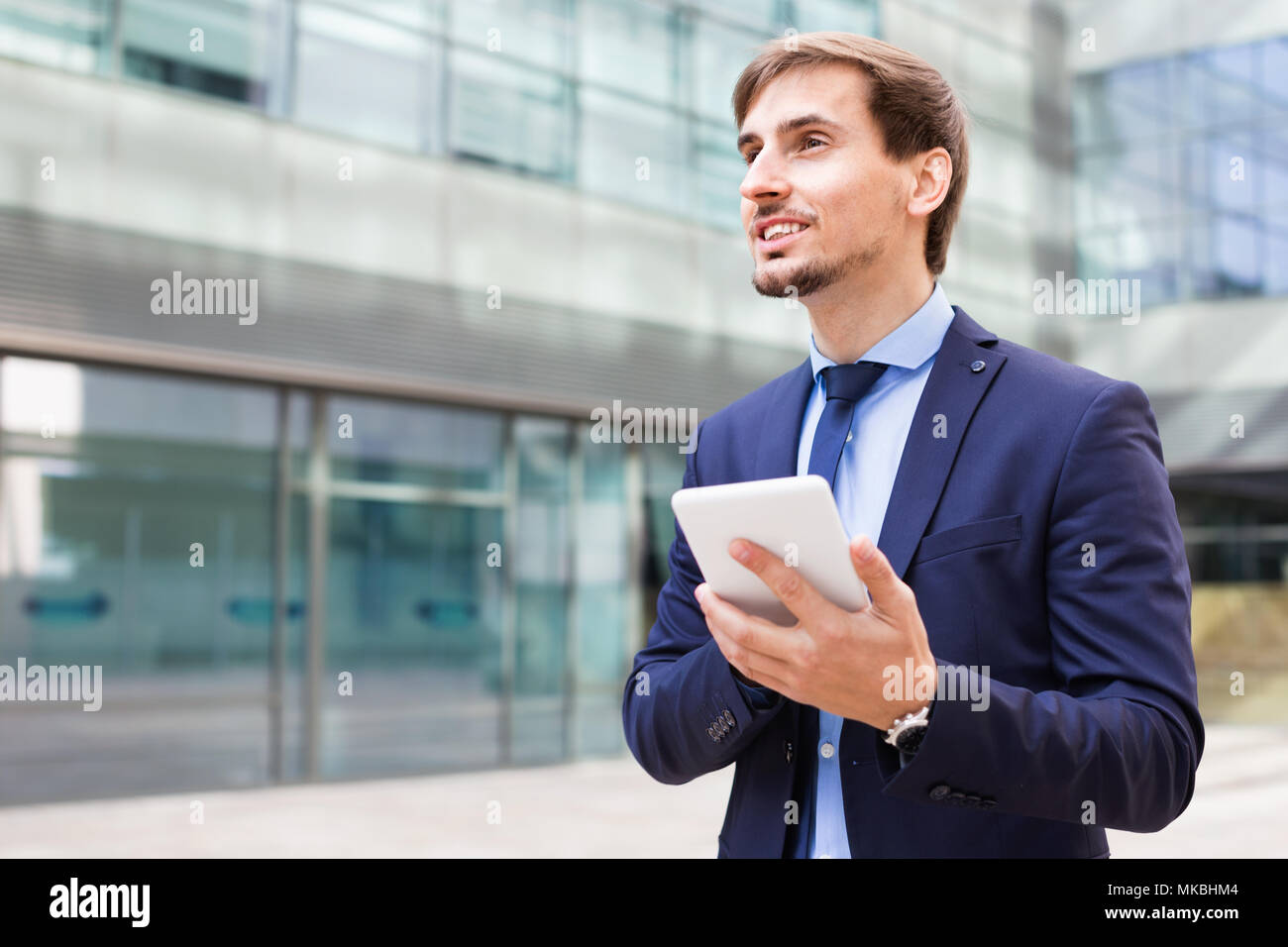 Happy male testing digital tablet and touchscreen in the big city Stock ...