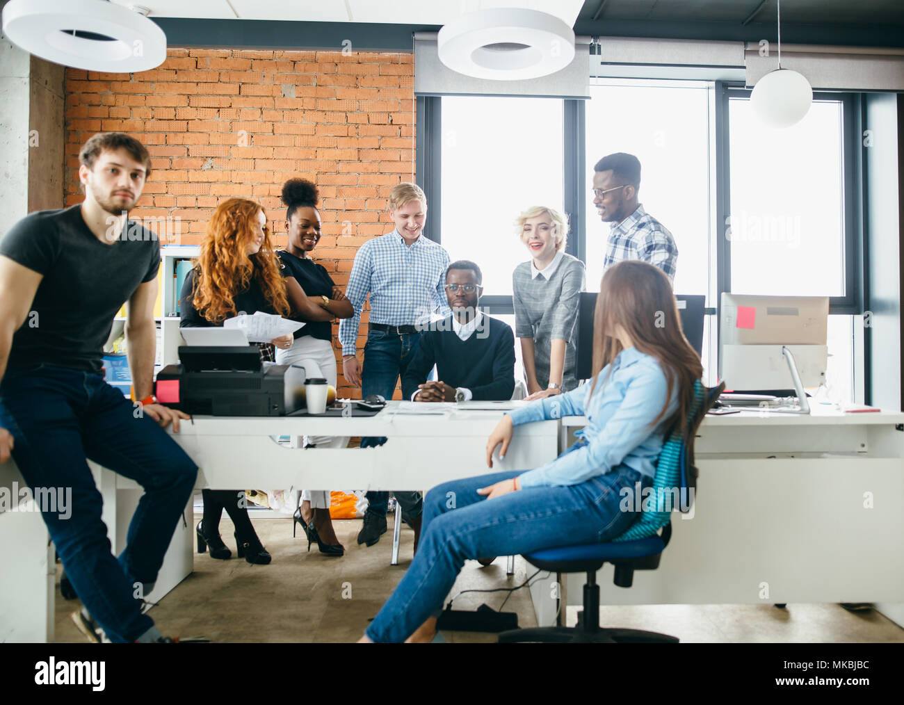 young serious black leader among happy partners. turn blind eyes to ...