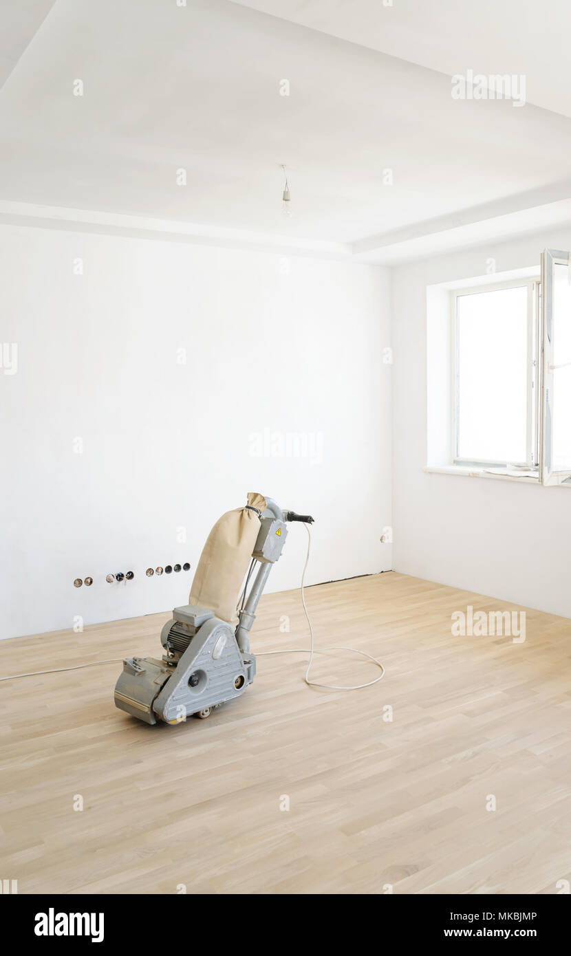 The grinding machine for wooden parquet floors on a oak parquet Stock ...