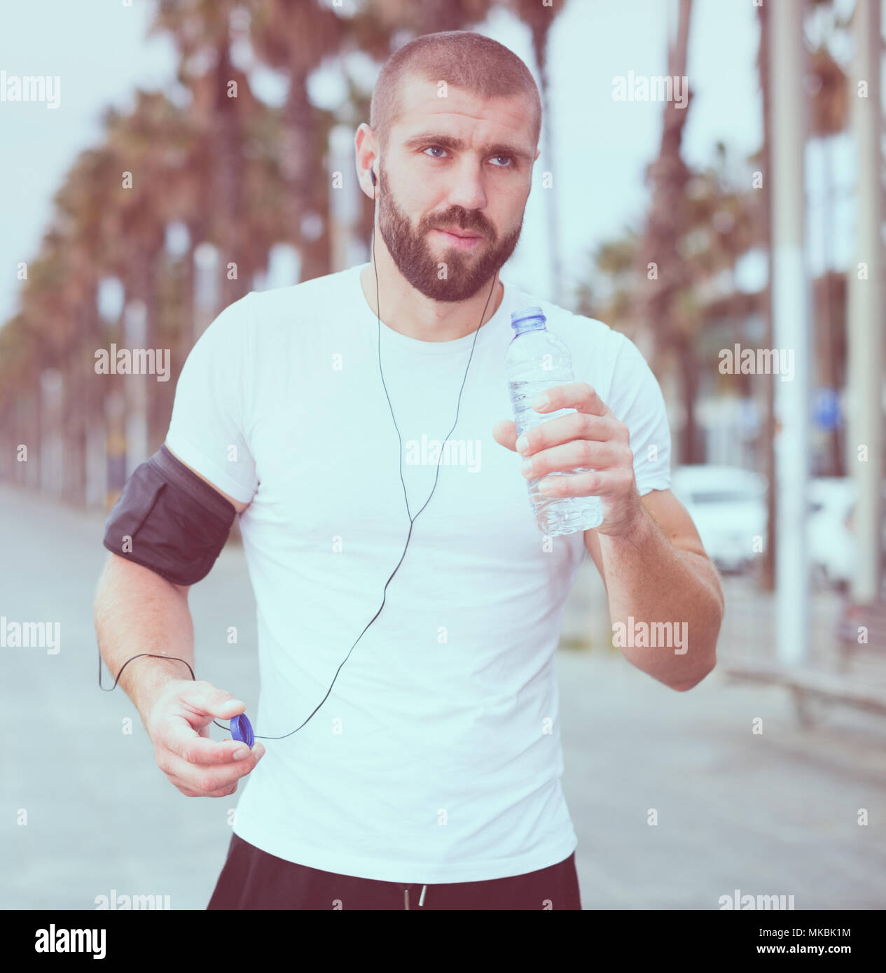 Athletic male stopped to rest while running Stock Photo - Alamy