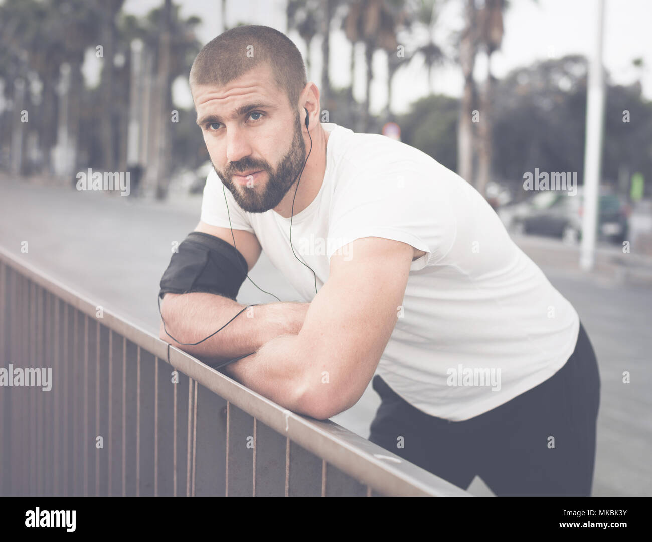 Athletic male stopped to rest while running Stock Photo - Alamy