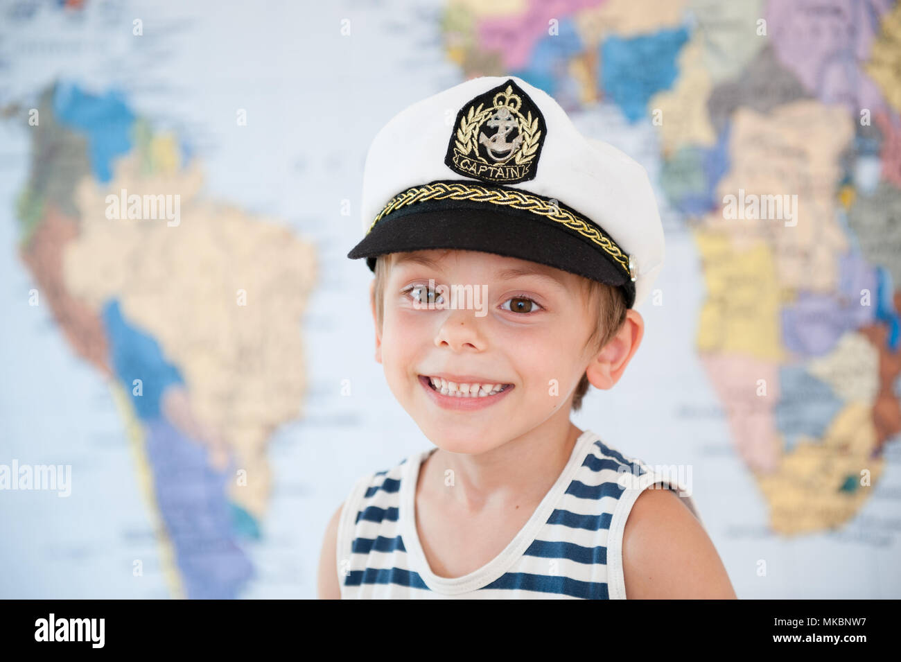 happy adorable kid in captain hat on world map background Stock Photo ...