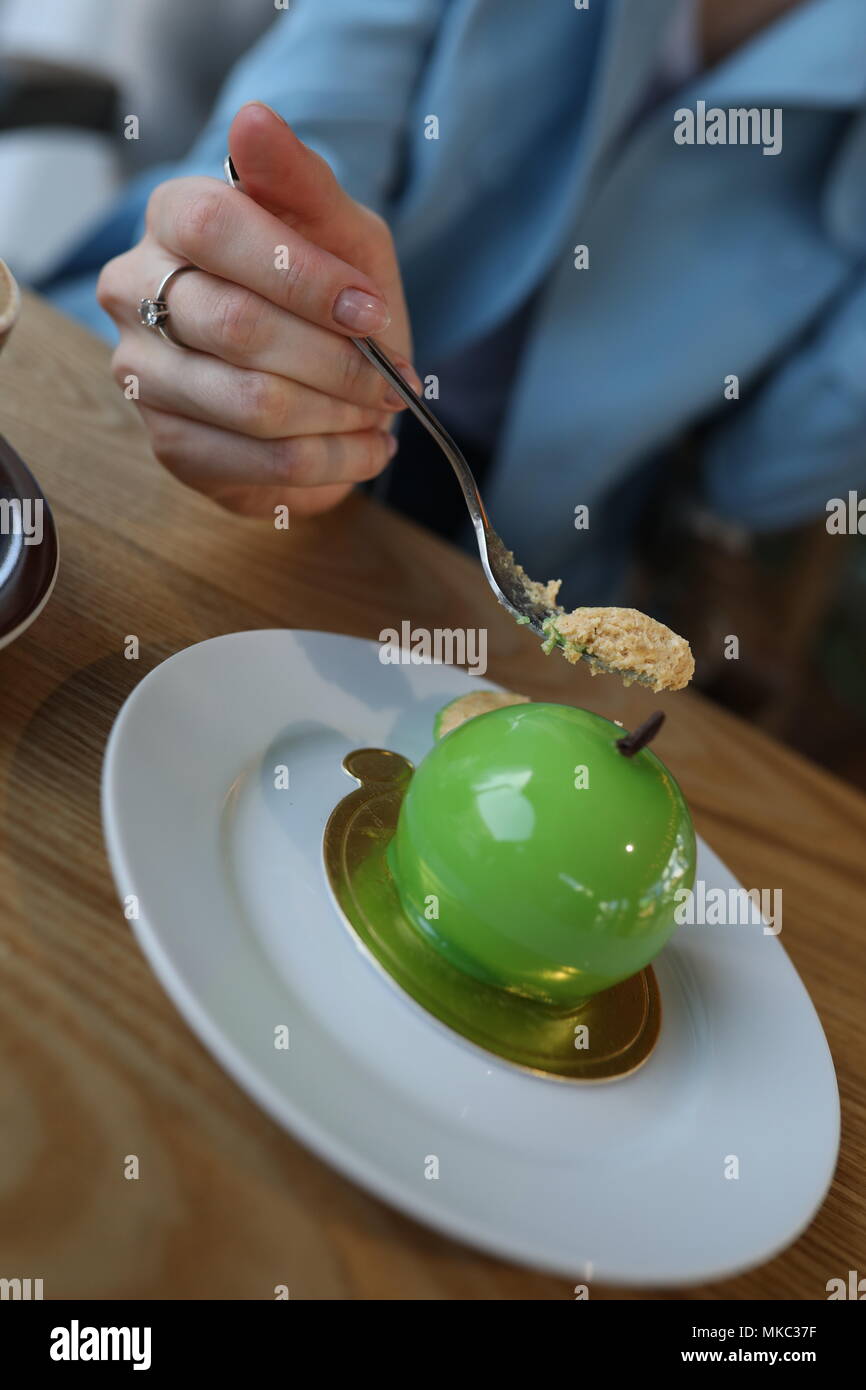 Close-up of woman's hand holding fork to eating cake Stock Photo - Alamy