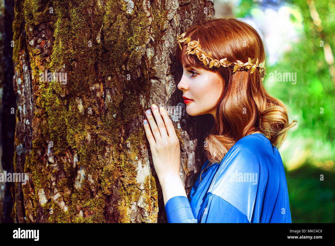 Woman sitting against tree trunk hi-res stock photography and images ...