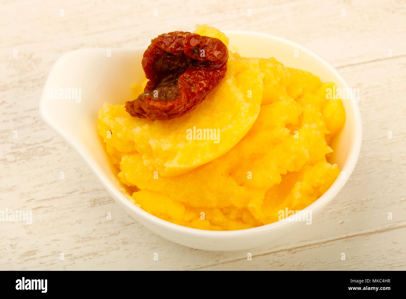 Polenta with dry tomato Stock Photo - Alamy