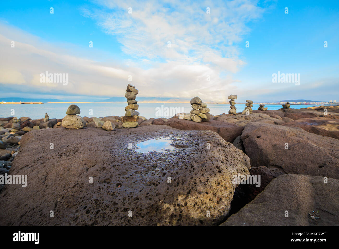 Series of stacked rock columns called cairns facing the sea in ...