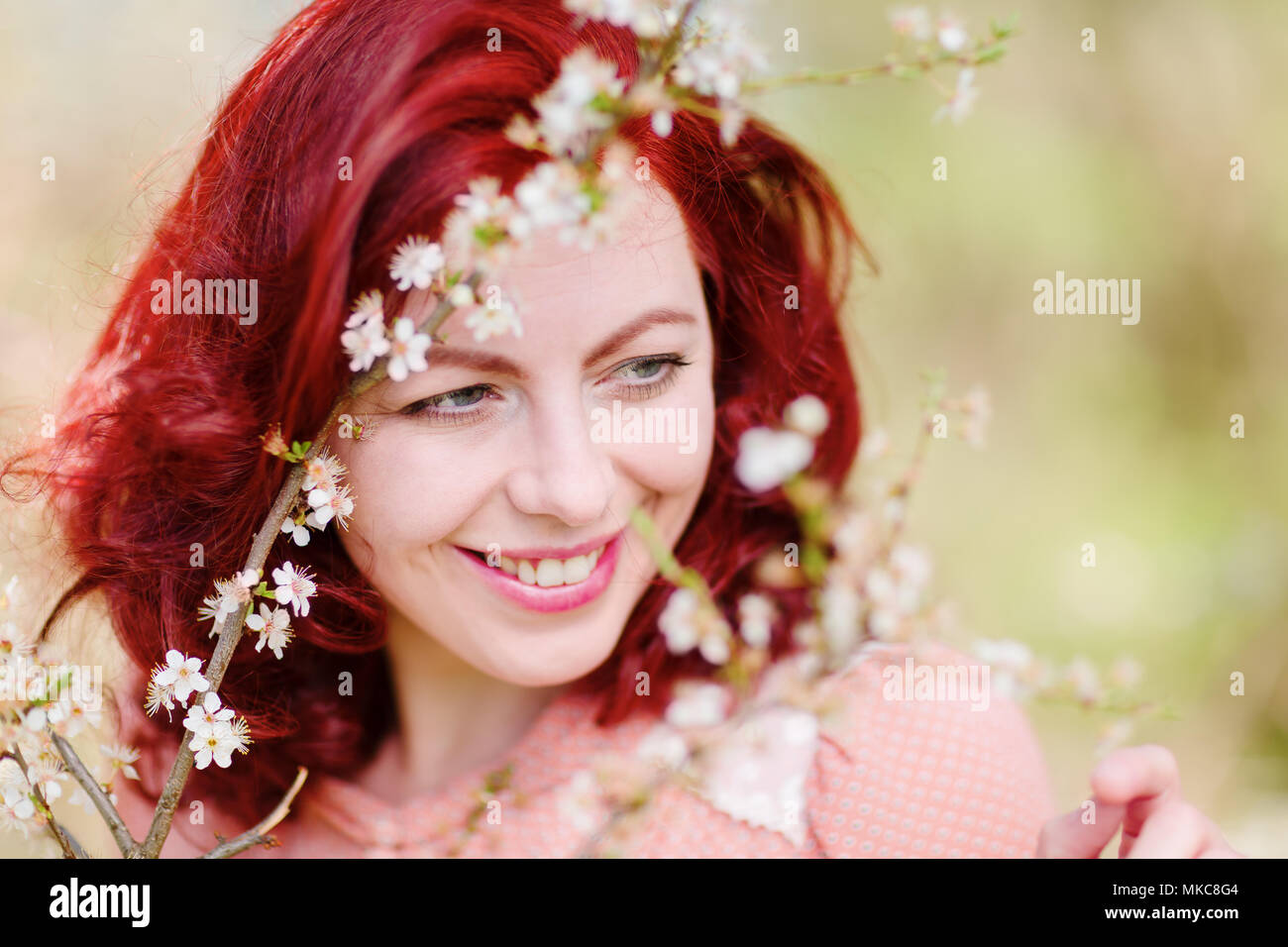 portrait of a beautiful woman in a flowering tree Stock Photo - Alamy