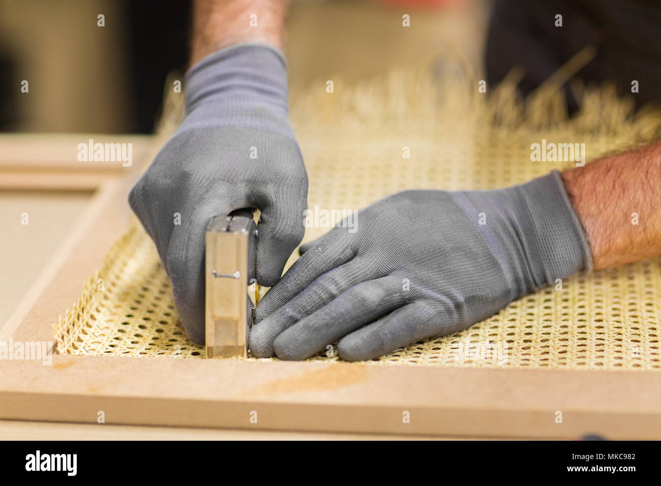 assembler with staple gun making furniture Stock Photo - Alamy