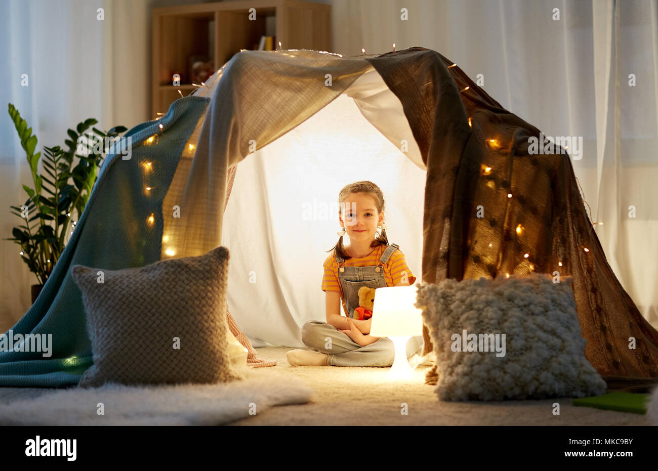 little girl with toys in kids tent at home Stock Photo - Alamy