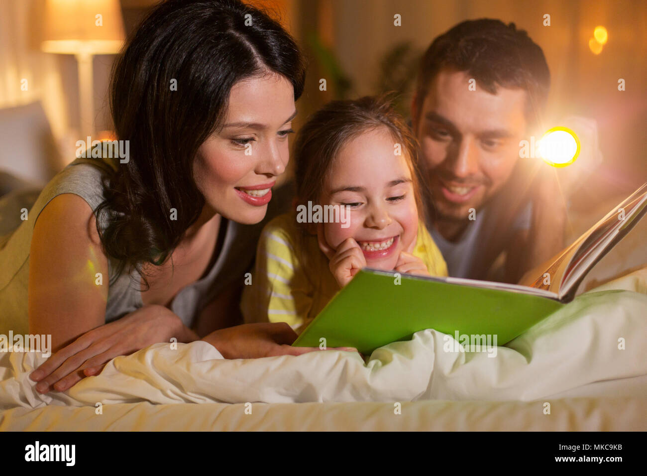 Child parent reading flashlight hi-res stock photography and images - Alamy