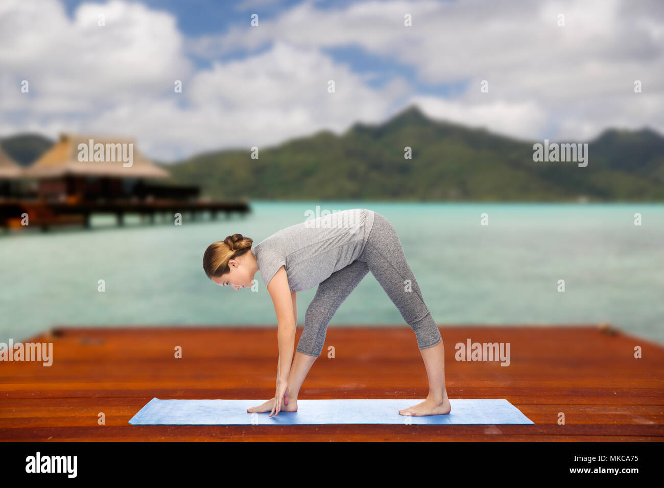 woman making yoga intense stretch pose outdoors Stock Photo - Alamy