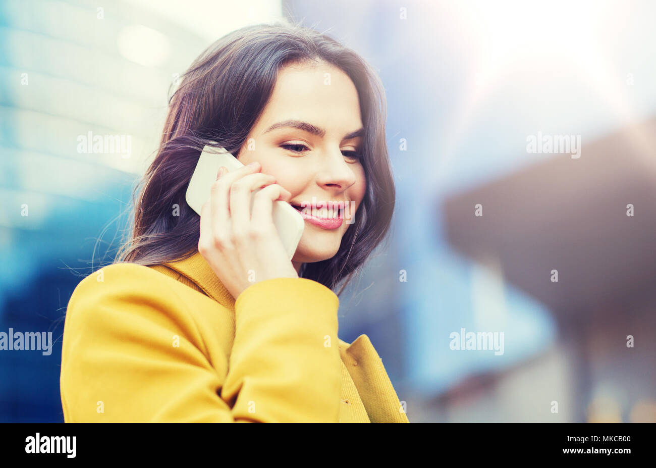 smiling young woman or girl calling on smartphone Stock Photo - Alamy