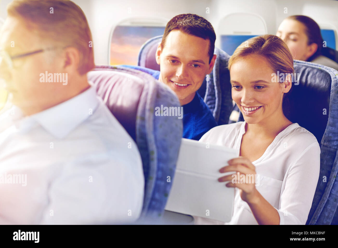 happy passengers with coffee talking in plane Stock Photo - Alamy
