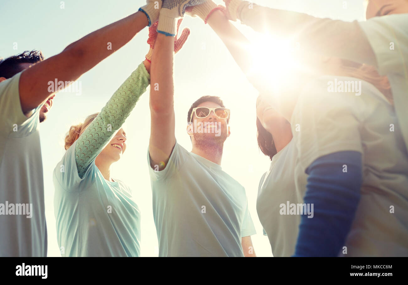 group of volunteers making high five outdoors Stock Photo - Alamy