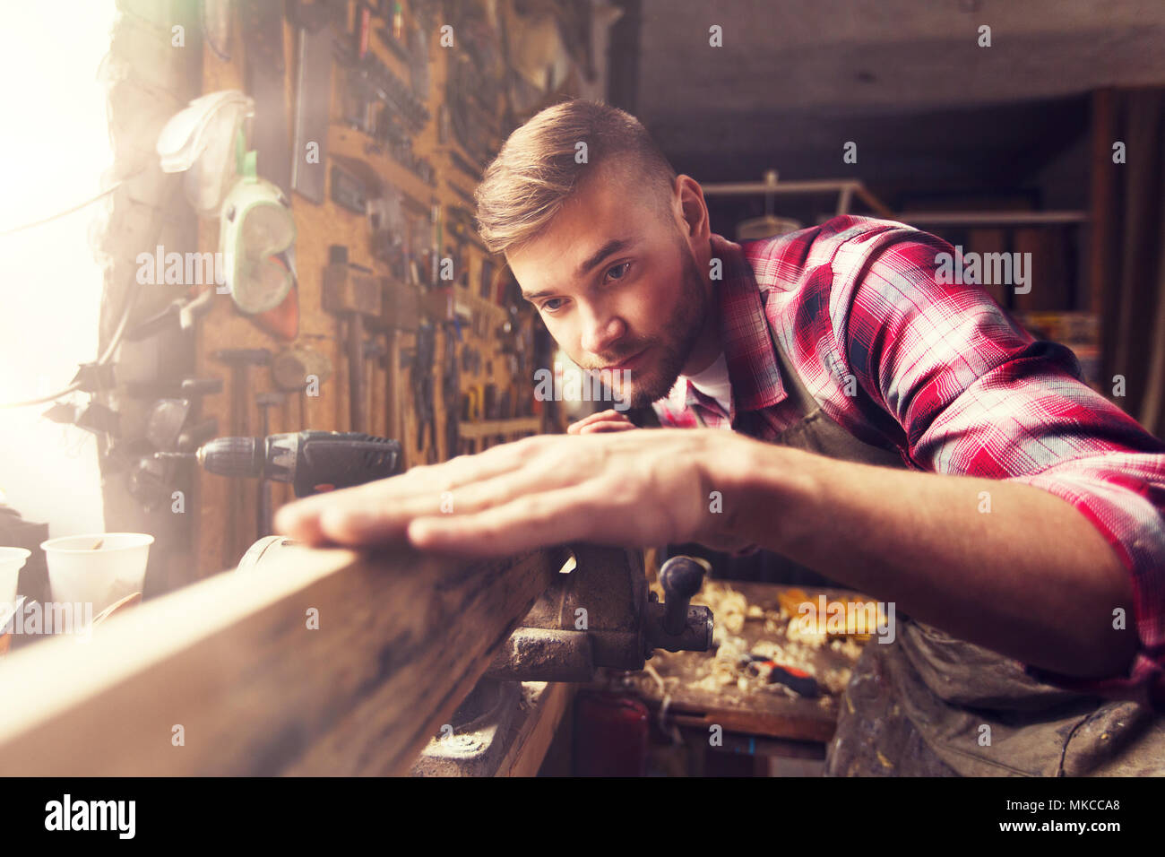 carpenter working with wood plank at workshop Stock Photo - Alamy
