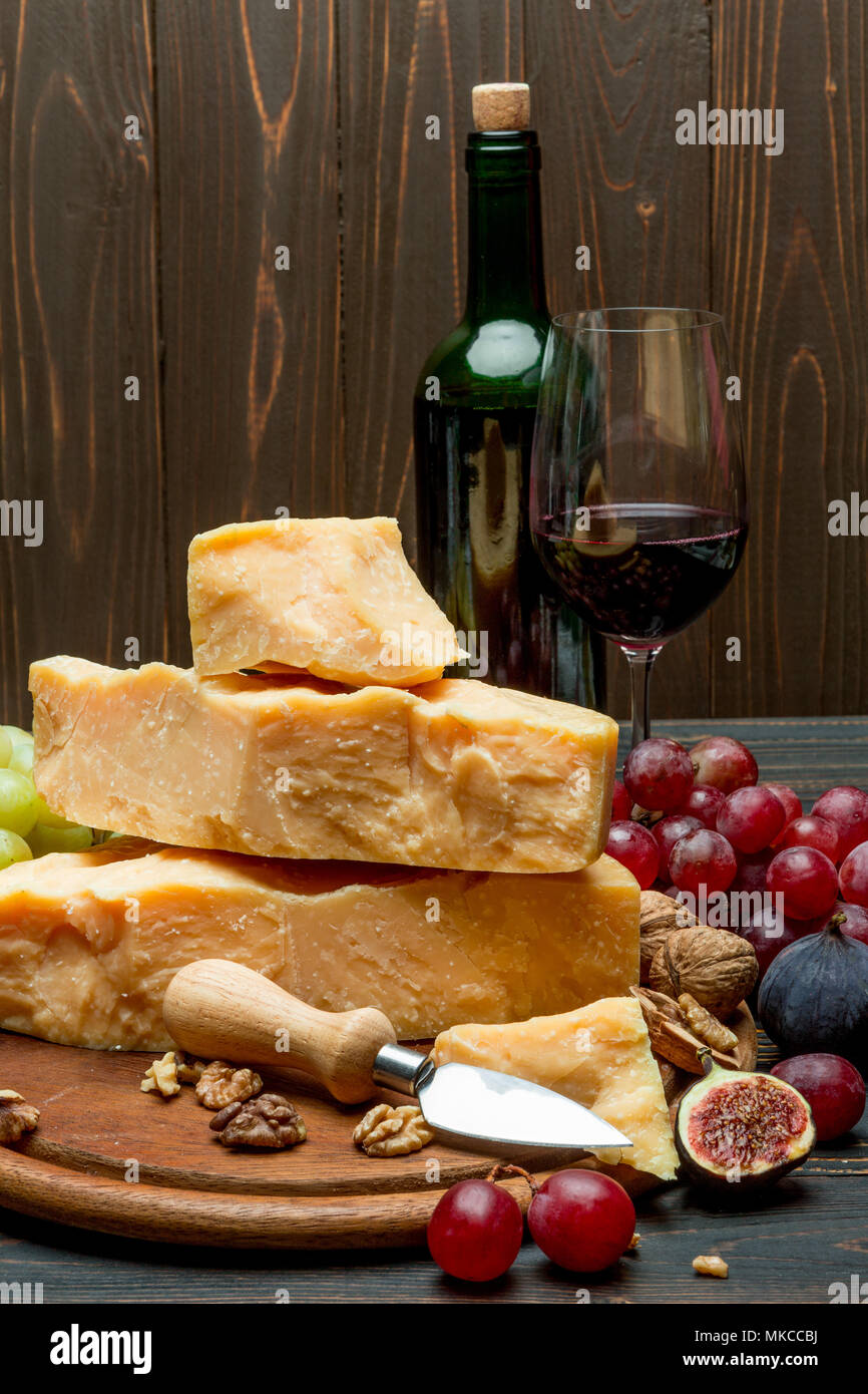 pieces of parmesan or parmigiano cheese, grapes and wine Stock Photo ...