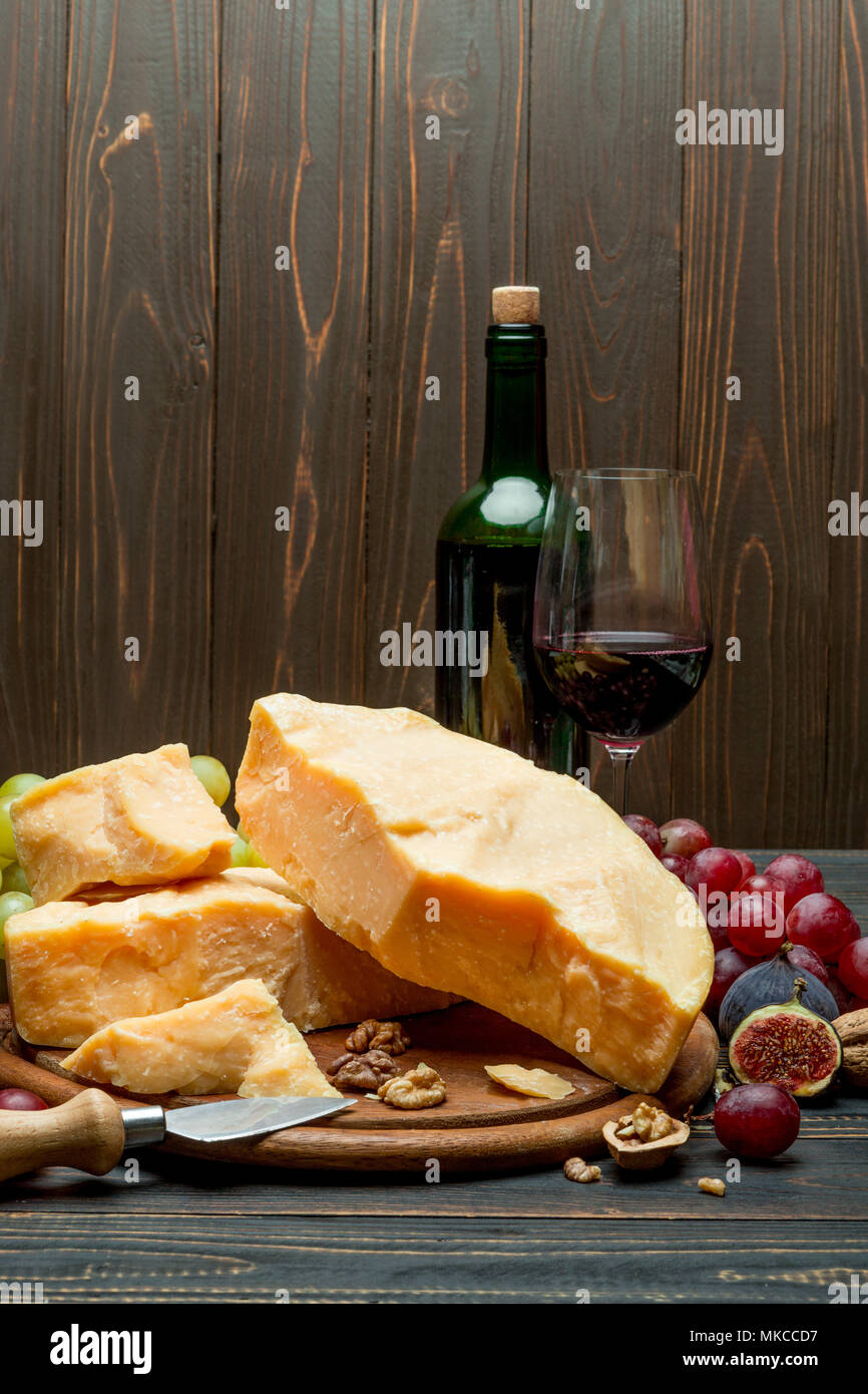pieces of parmesan or parmigiano cheese, grapes and wine Stock Photo ...