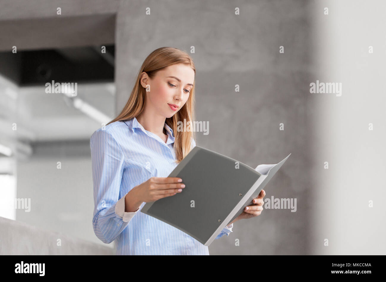 female office worker with folder Stock Photo - Alamy