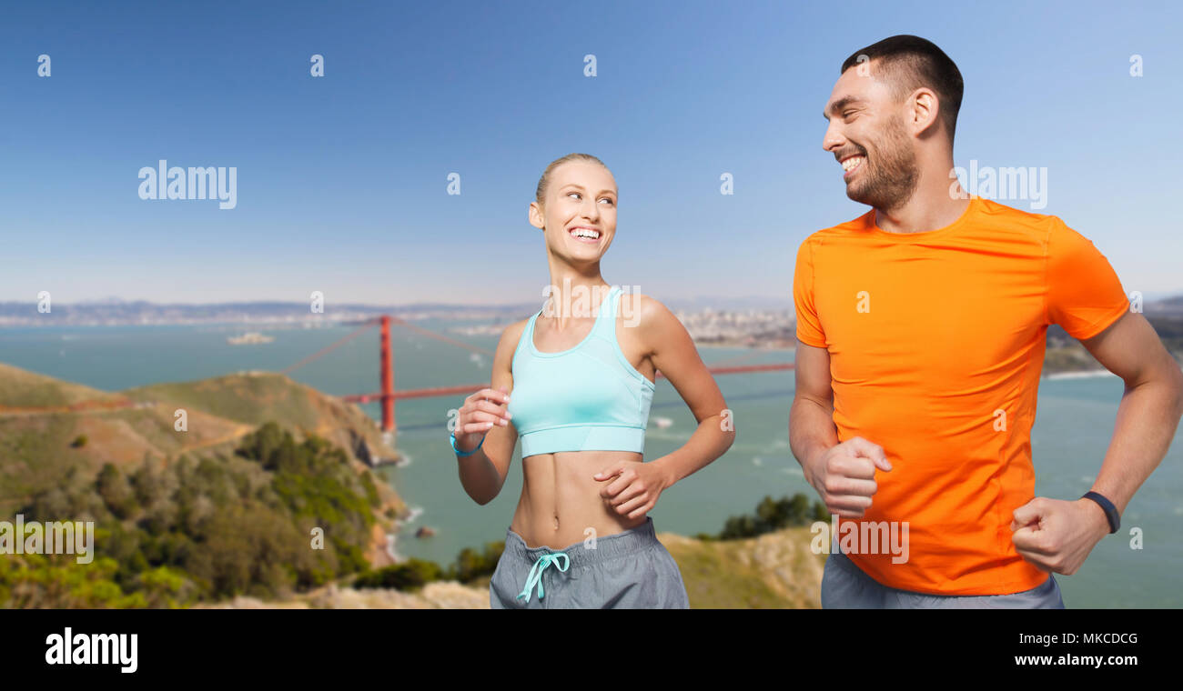 couple running over golden gate bridge background Stock Photo - Alamy