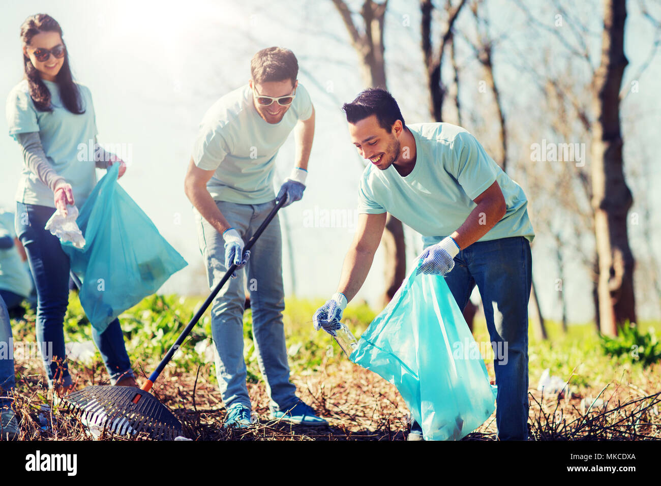 volunteers with garbage bags cleaning park area Stock Photo - Alamy