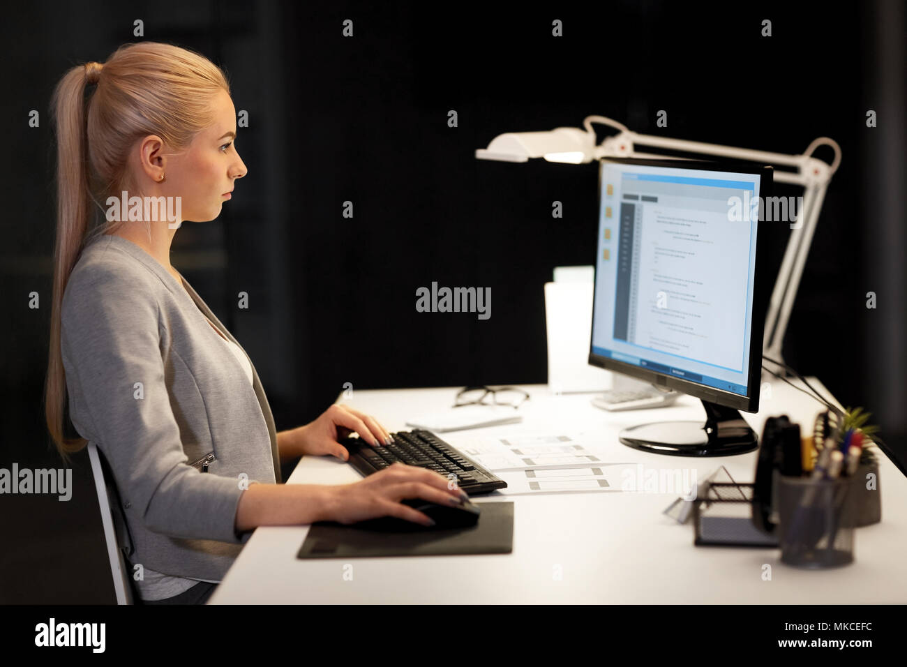 Female office worker working late hi-res stock photography and images ...