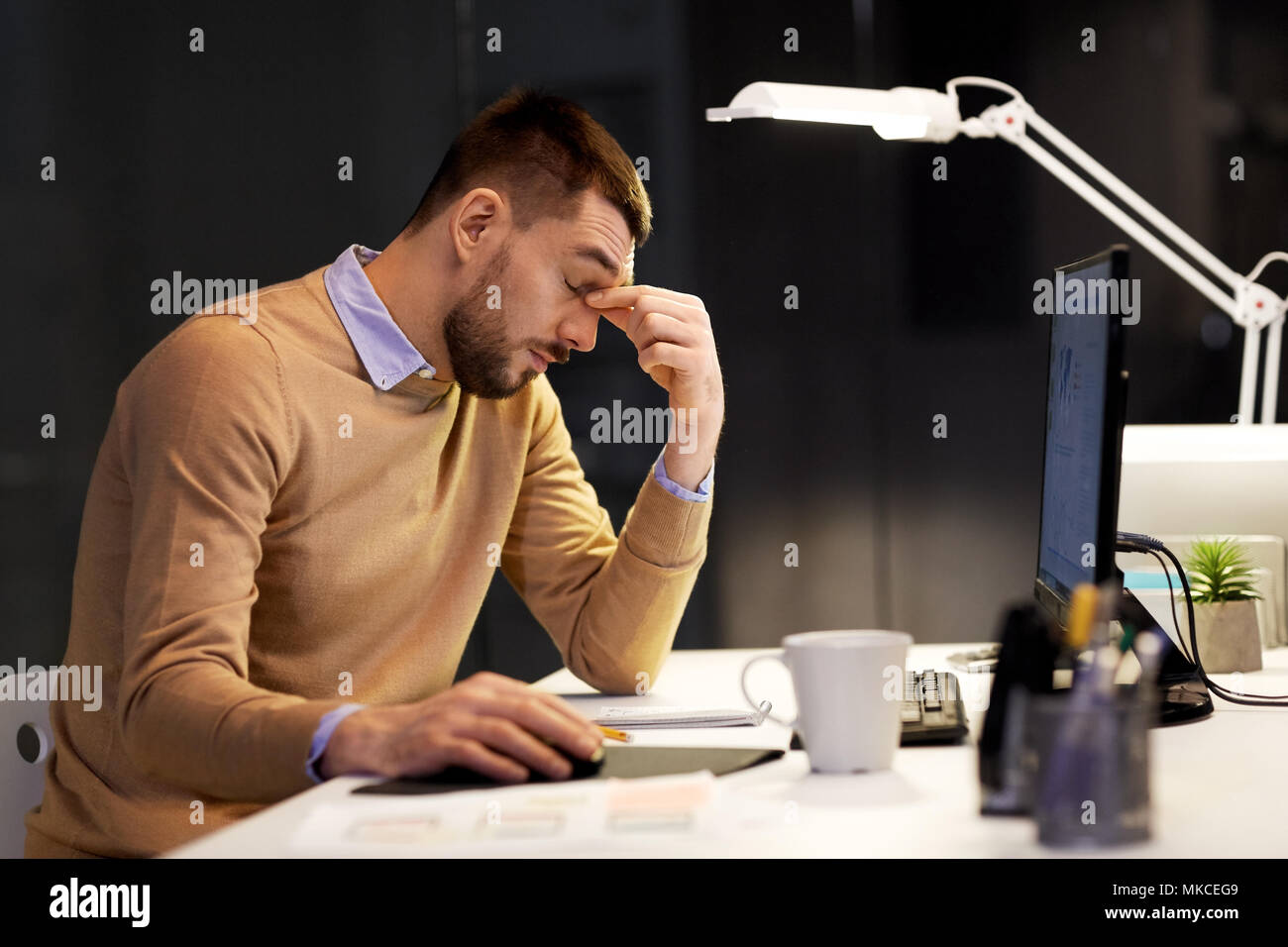 tired businessman working at night office Stock Photo - Alamy